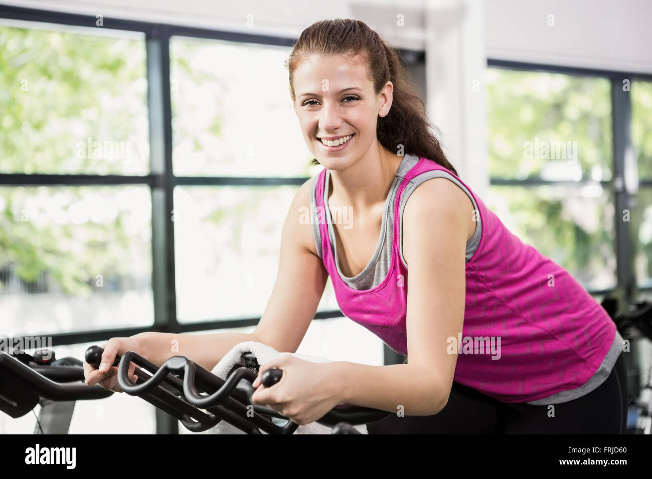Woman working out on exercise bike at spinning class Stock Photo - Alamy