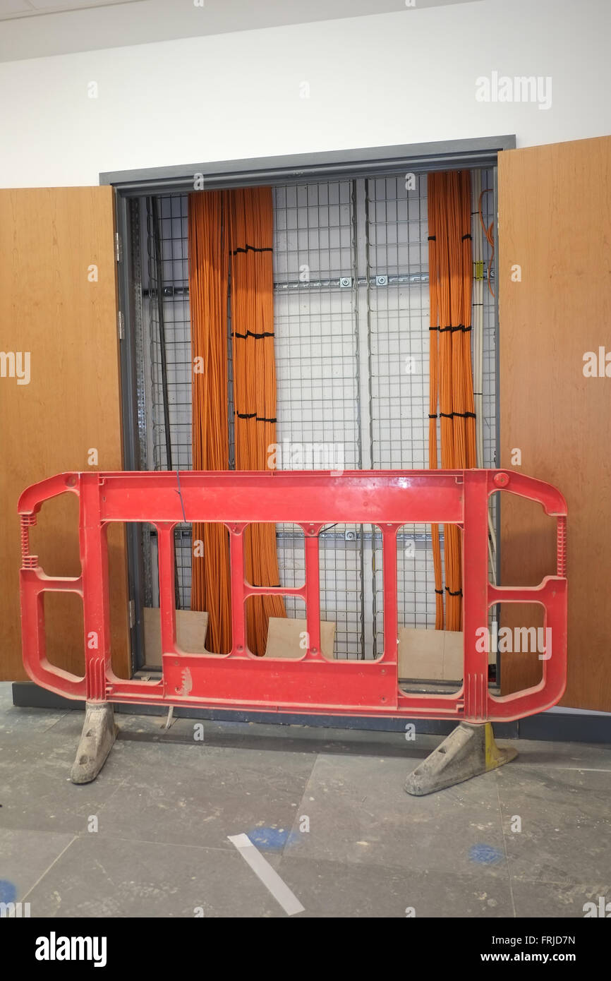 Safety Barriers Across An Open Data Or Electrical Riser Cupboard Stock
