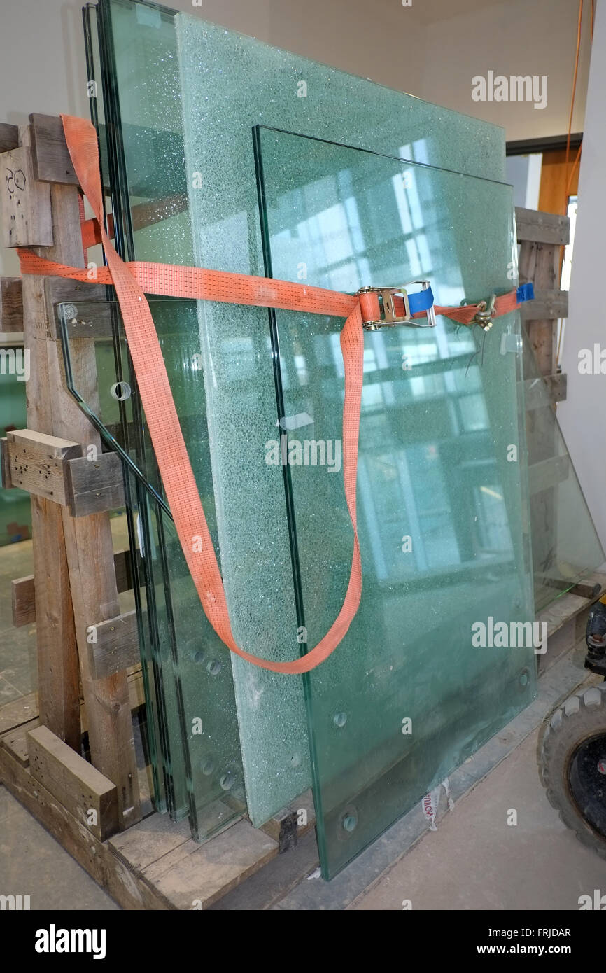 Broken pane of glass on a stilage or pallet on a construction site ...