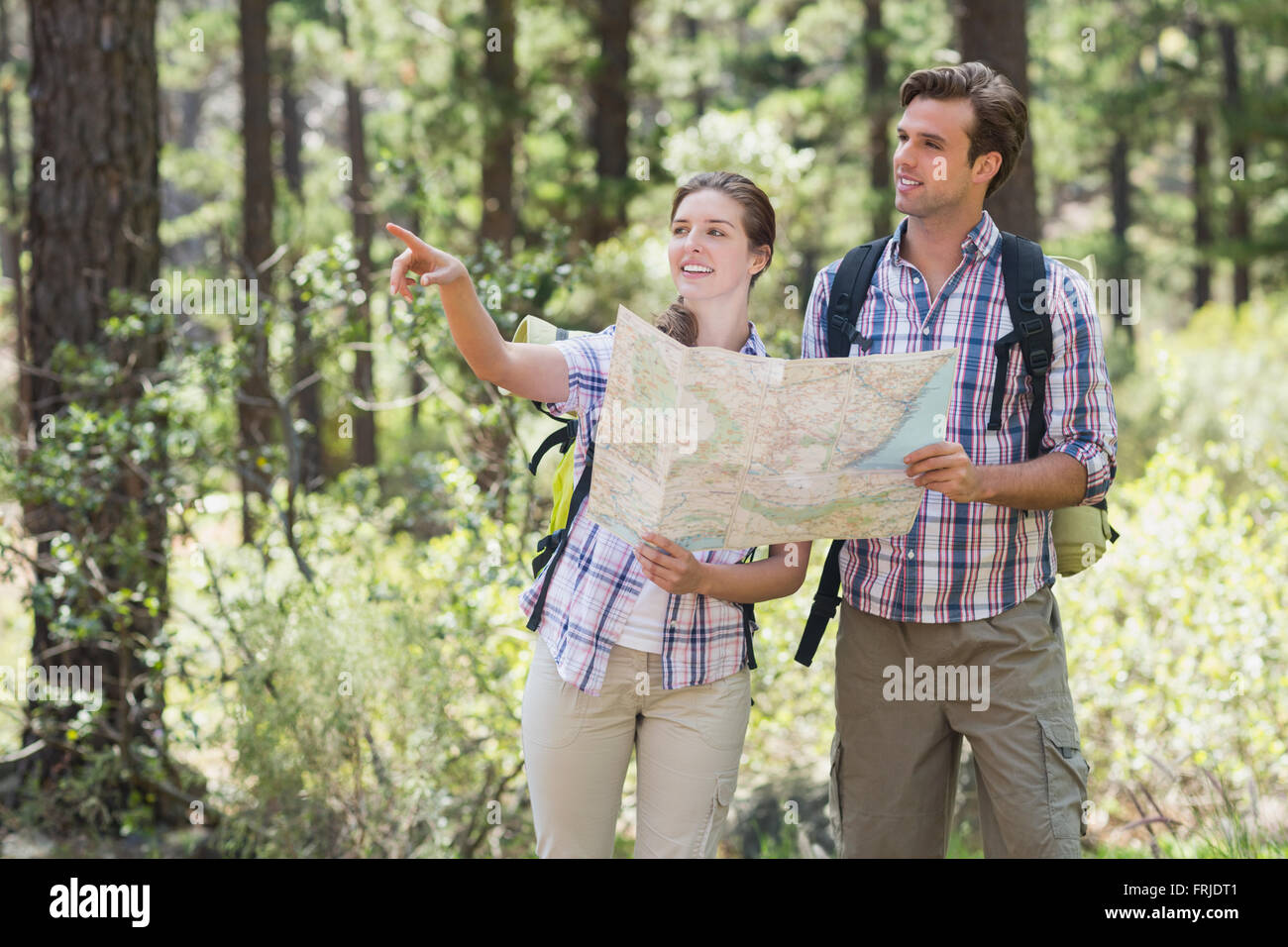 Woman pointing and showing partner during hiking Stock Photo - Alamy