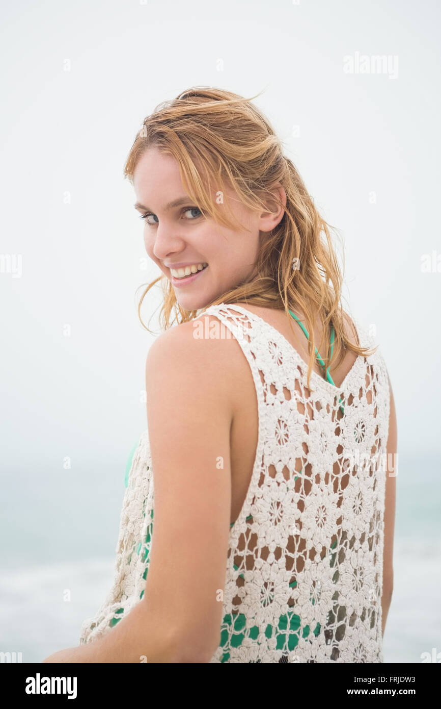 Pretty blonde woman looking back at the camera Stock Photo - Alamy