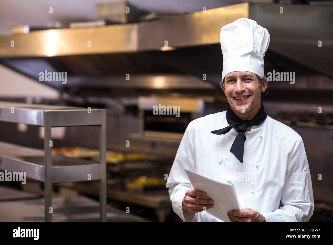 Handsome chef holding menu Stock Photo - Alamy