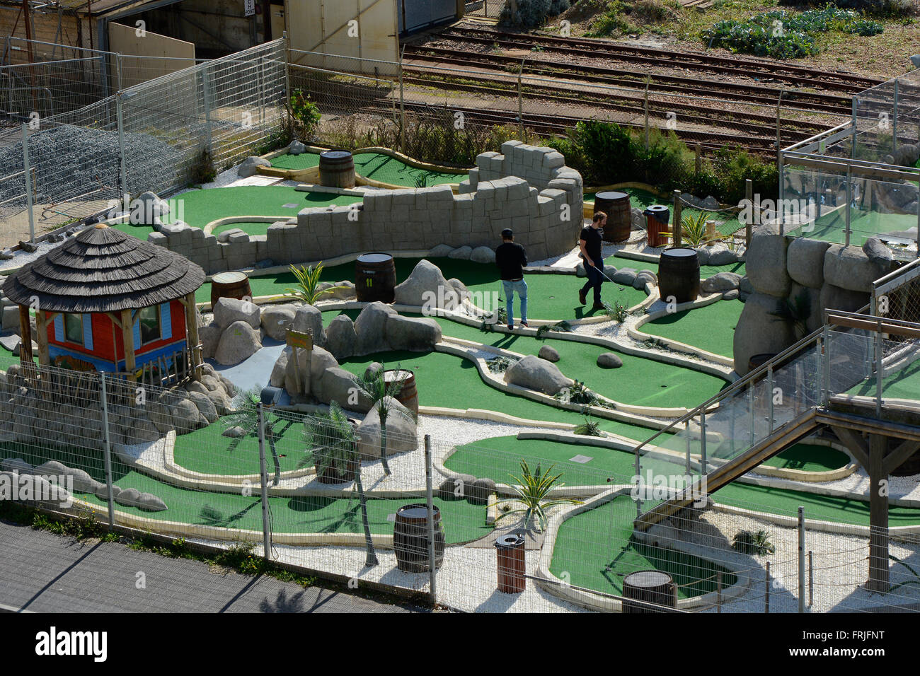 People playing Crazy Golf or Mini Golf on the beach at Brighton ...