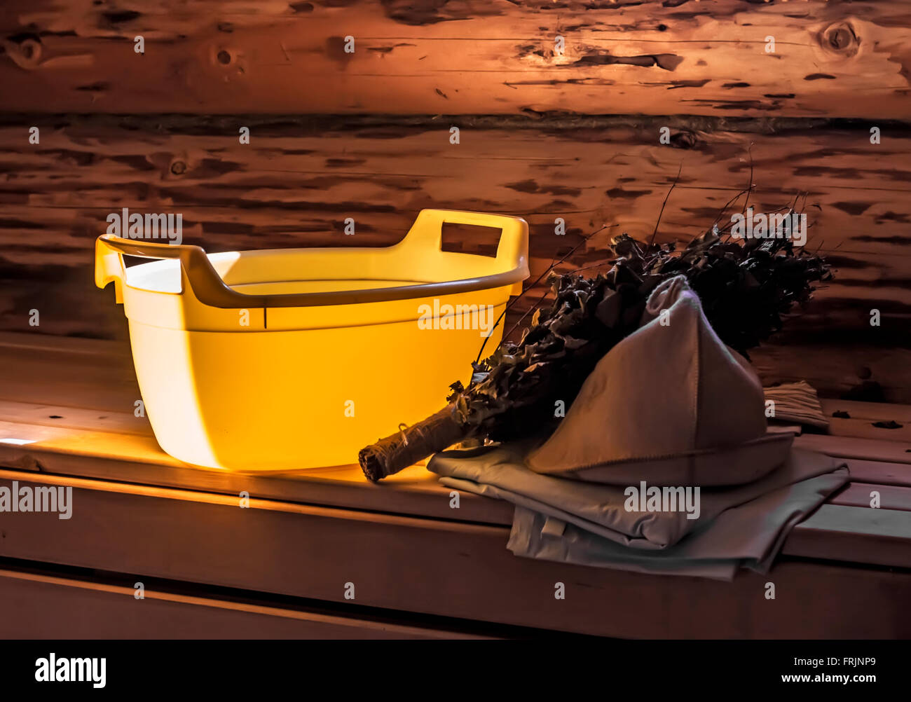 Yellow plastic basin in sauna lit by sun Stock Photo - Alamy