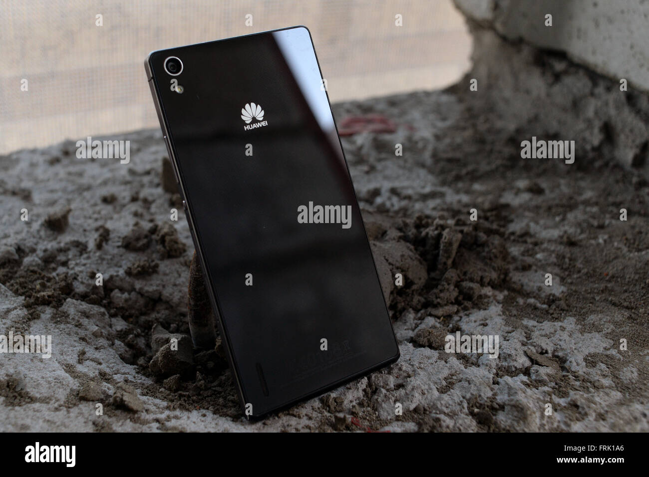 The Huawei smartphone stands on concrete wall Stock Photo - Alamy