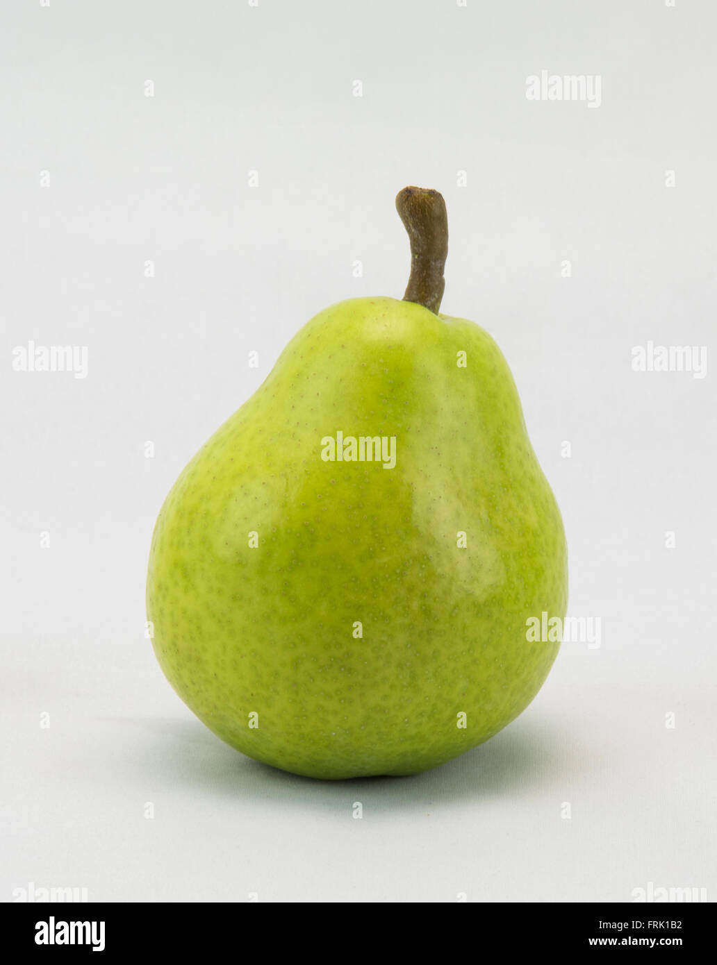 A single pear against a white background Stock Photo - Alamy