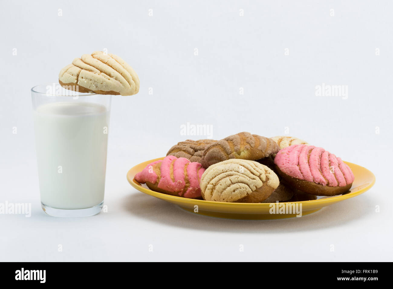 Glass of milk next to a plate of Concha bread Stock Photo - Alamy