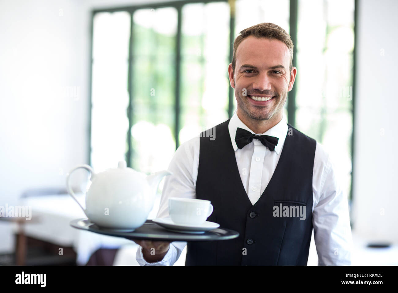 Waiter smiling at camera Stock Photo - Alamy