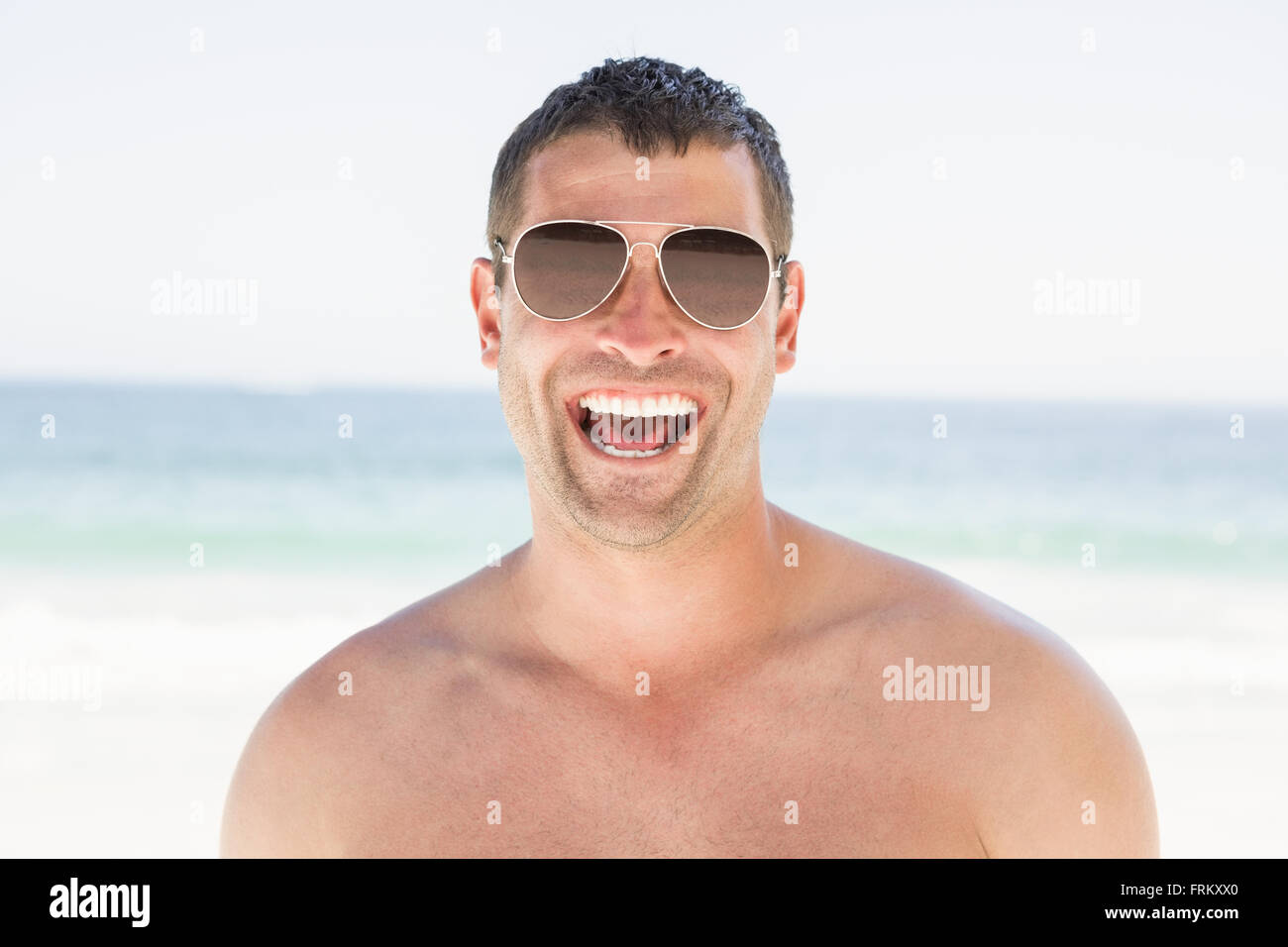 Portrait of smiling man on the beach Stock Photo - Alamy