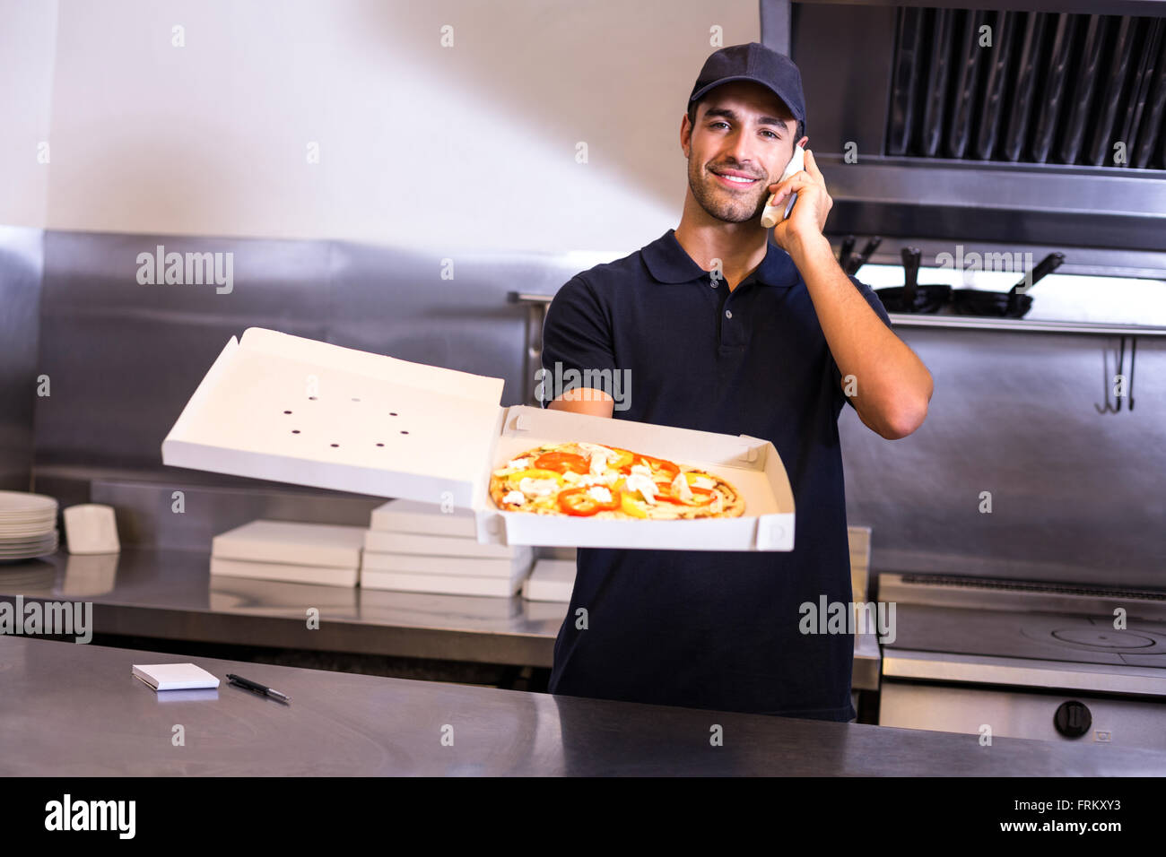 Pizza delivery man holding phone hi-res stock photography and images ...