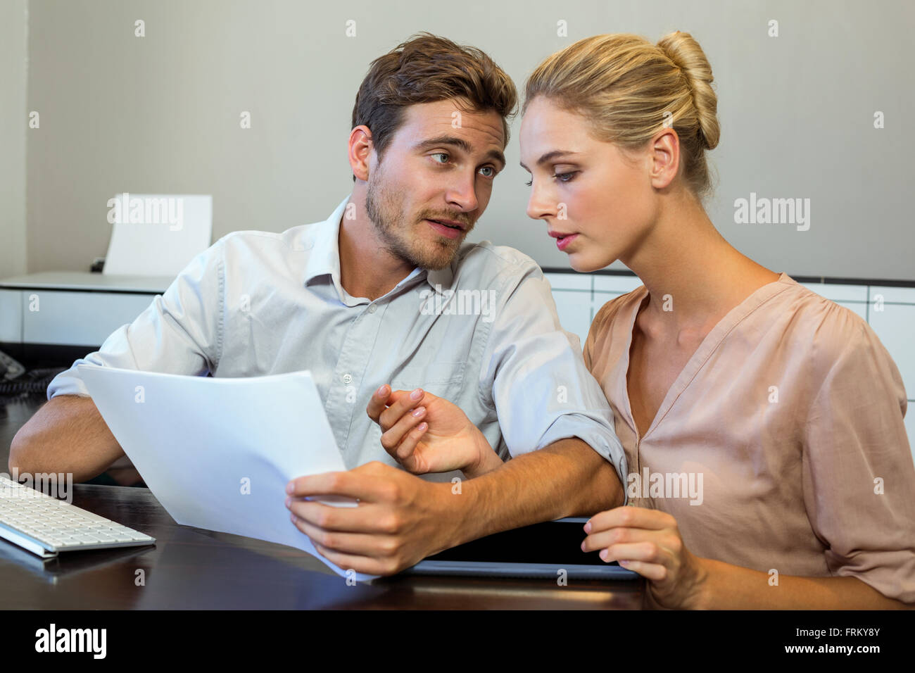Colleagues looking paper desk office hi-res stock photography and ...