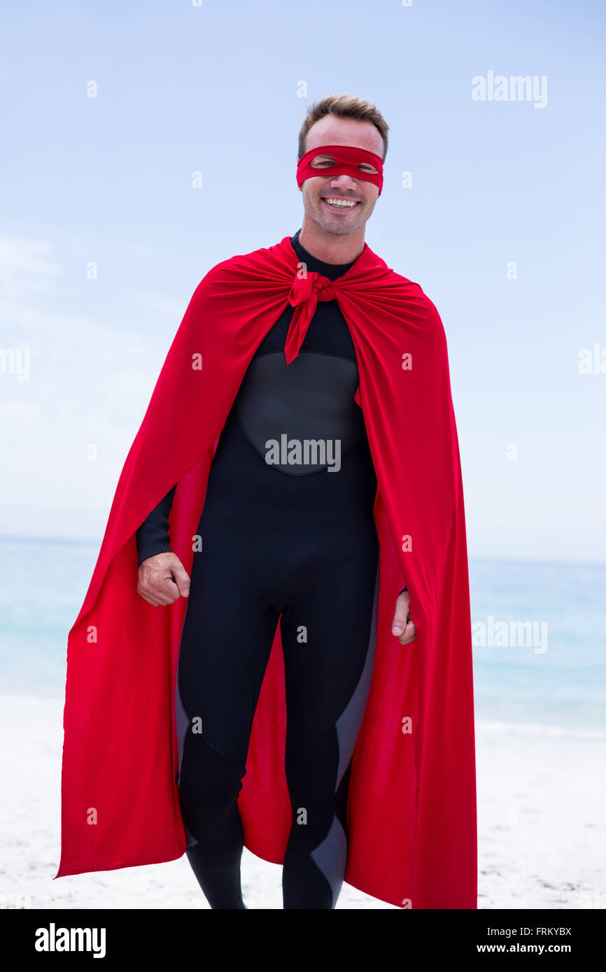 Man in superhero costume walking at sea shore Stock Photo - Alamy