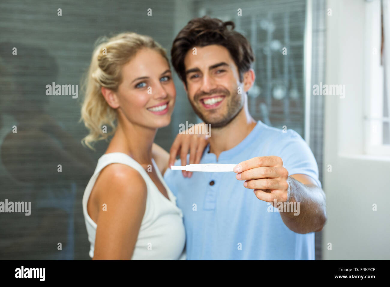 Happy couple checking pregnancy test Stock Photo - Alamy