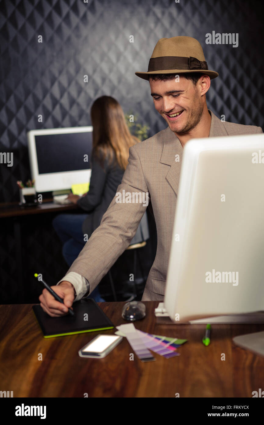 Creative businessman using computer and graphic tablet Stock Photo - Alamy