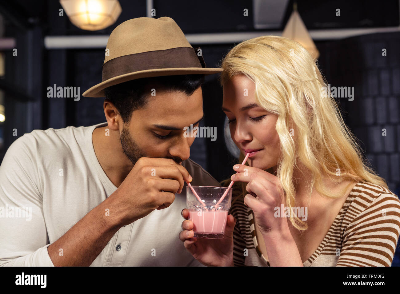 Couple sharing a milkshake Stock Photo - Alamy