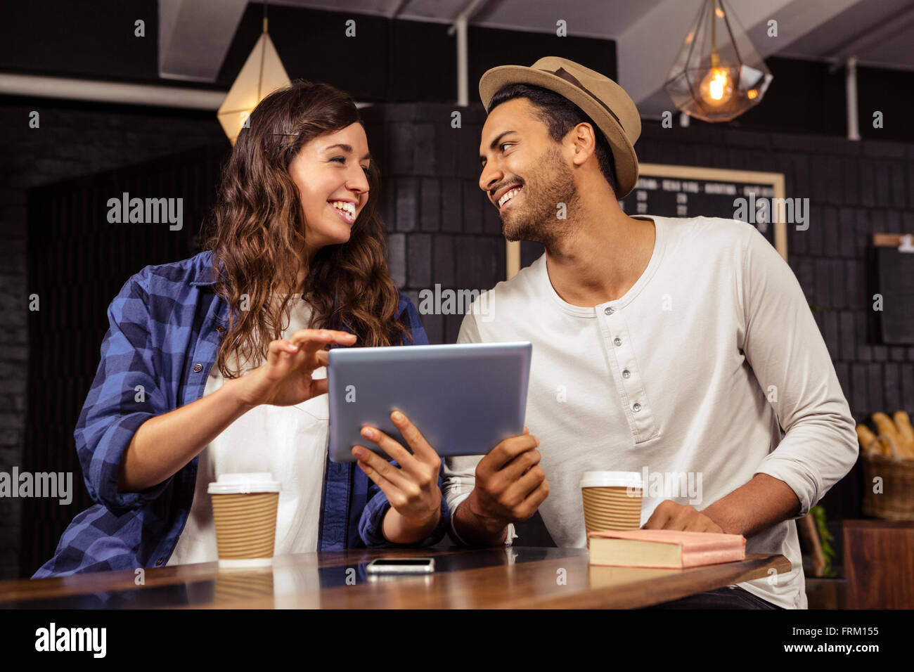 Couple using a tablet Stock Photo - Alamy