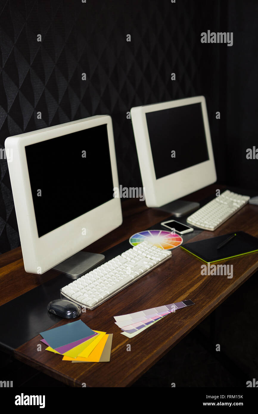 Two computers on a desk Stock Photo - Alamy