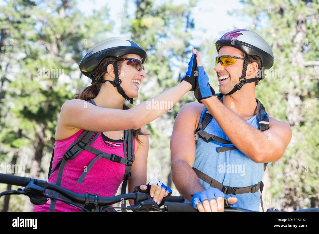 Couple giving high five standing hi-res stock photography and images ...