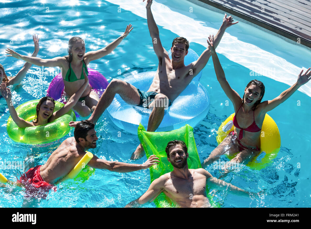 Group of friends having fun in swimming pool Stock Photo - Alamy