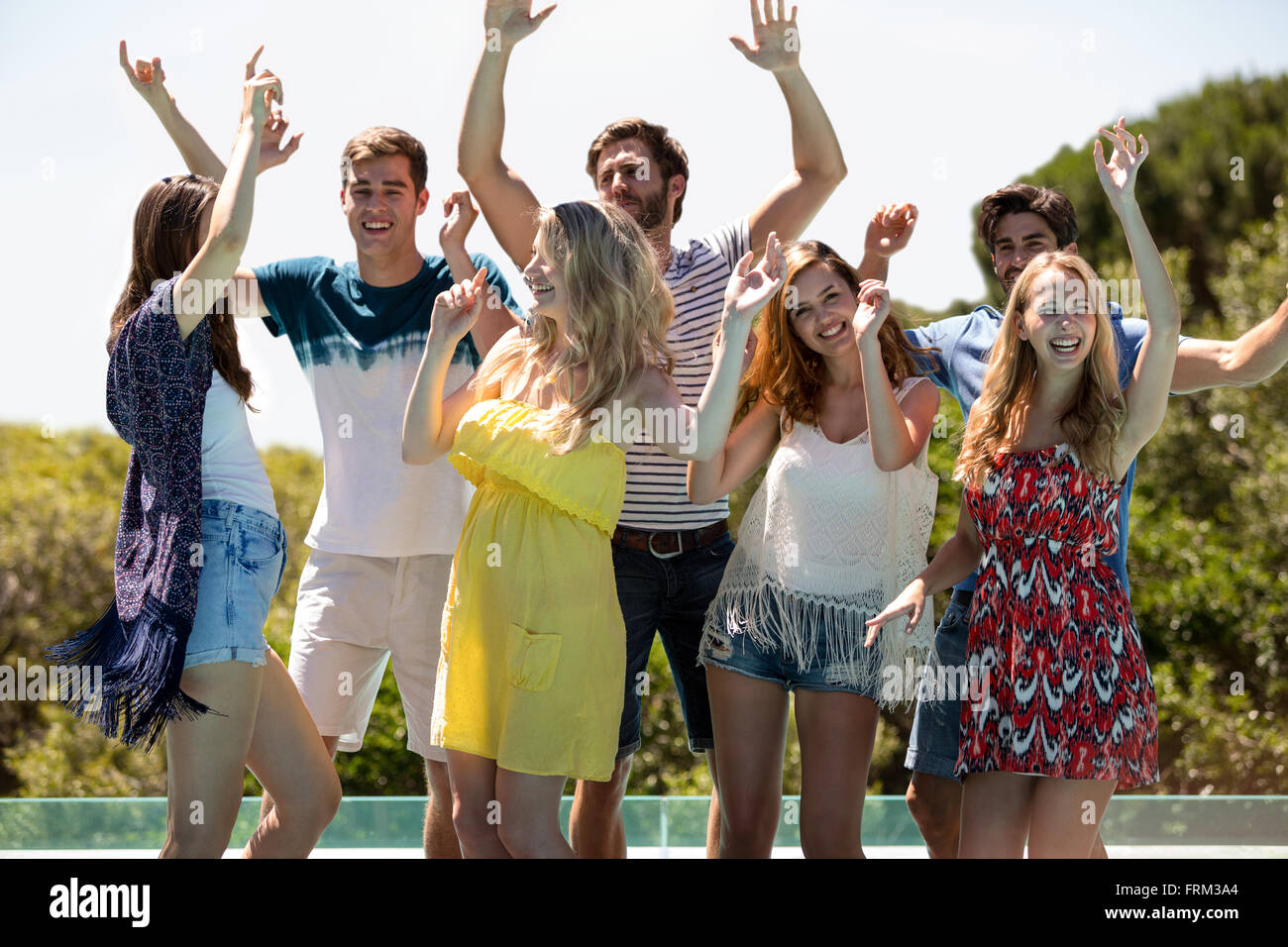 Happy friends dancing near the swimming pool Stock Photo - Alamy