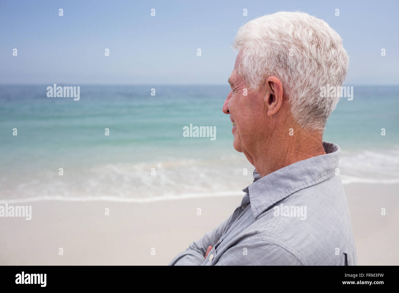 Happy senior man looking at sea Stock Photo - Alamy