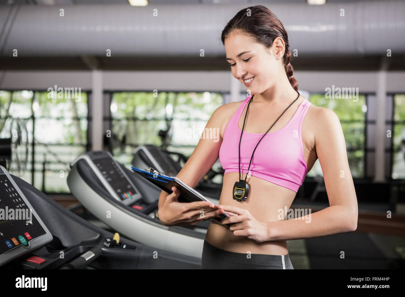 Trainer holding clipboard and stopwatch Stock Photo - Alamy