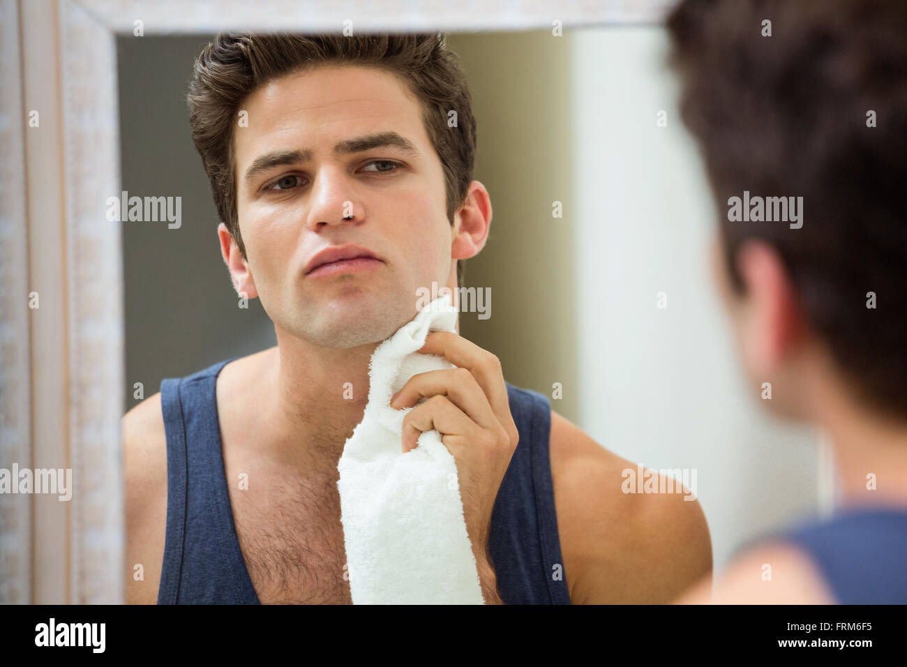 Man wiping his face with napkin Stock Photo - Alamy