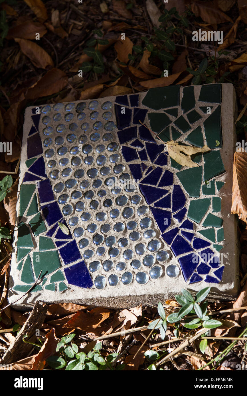 A patterned tile in a garden walk way Stock Photo - Alamy