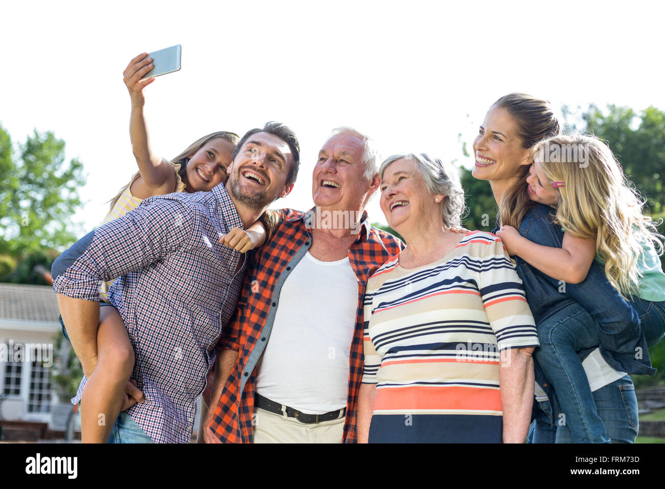 Cheerful girl taking selfie with multi-generation family Stock Photo ...