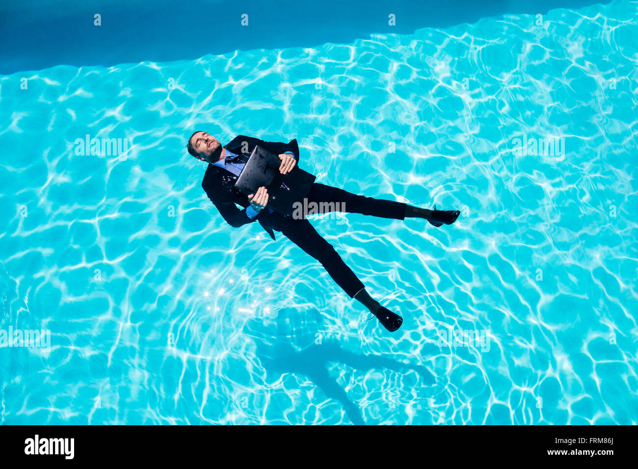 Dressed businessman in swimming pool Stock Photo - Alamy