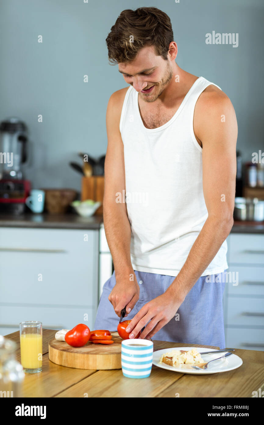 Happy man cutting vegetables in kitchen Stock Photo - Alamy