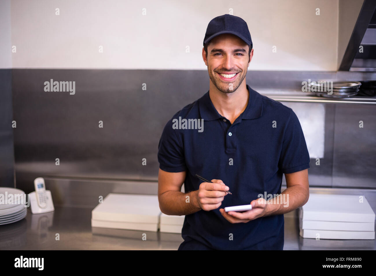 Pizza delivery man taking an order Stock Photo - Alamy