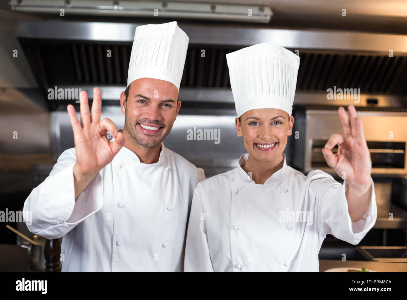 Portrait of happy chefs showing ok signs in kitchen Stock Photo - Alamy