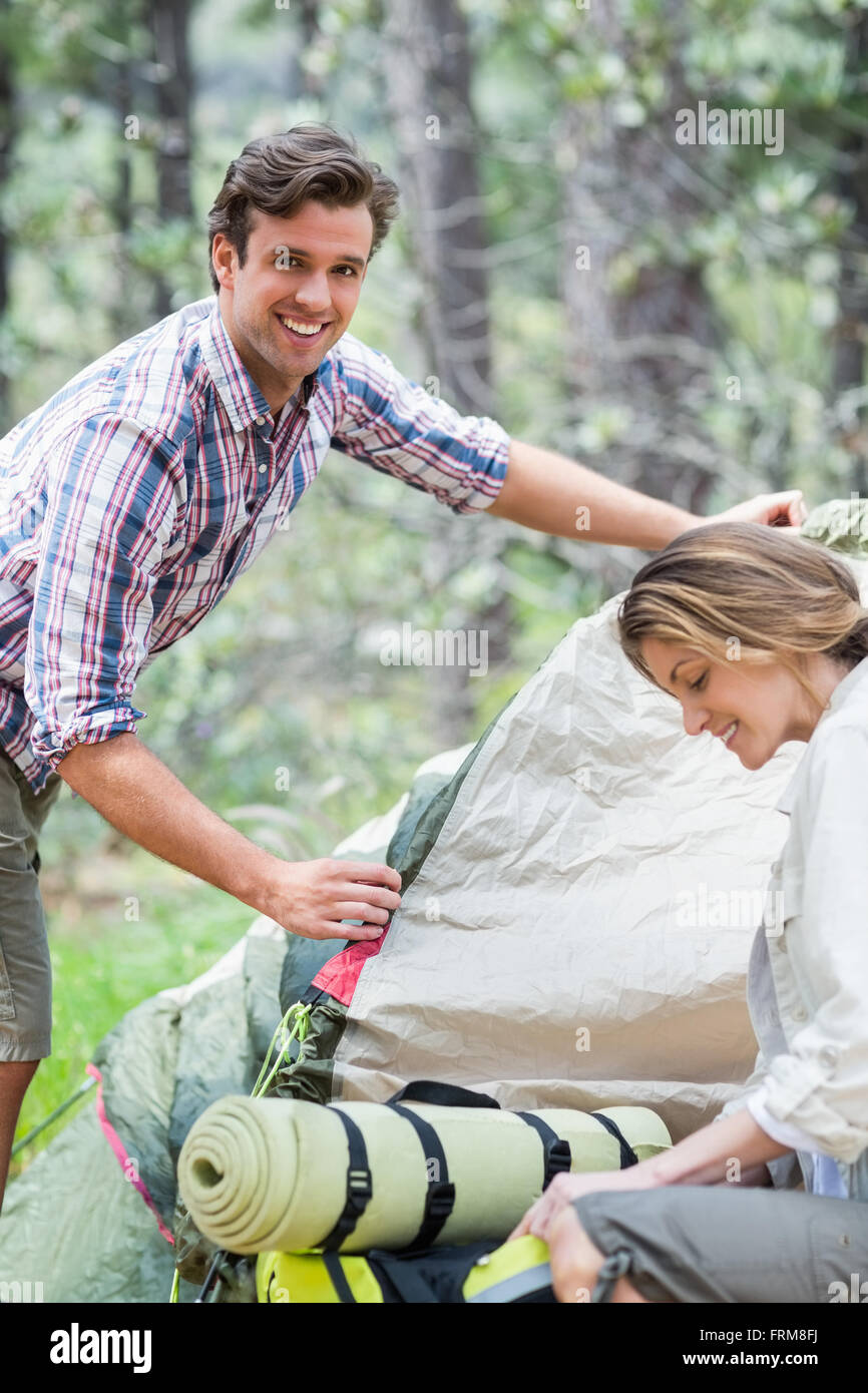 Portrait of man with partner making tent while hiking Stock Photo - Alamy