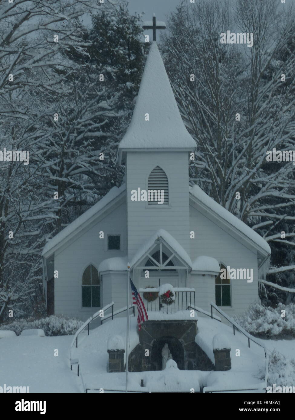 Catholic church covered by snow Stock Photo - Alamy