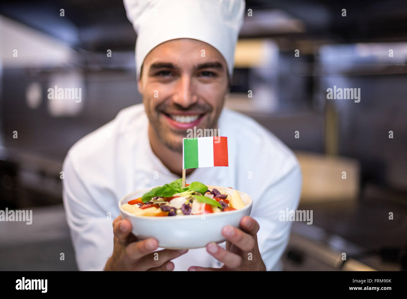 Handsome chef presenting meal with italian flag Stock Photo - Alamy