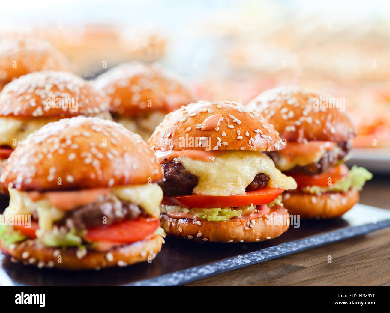 burgers with cheese and beef on the kitchen table Stock Photo - Alamy