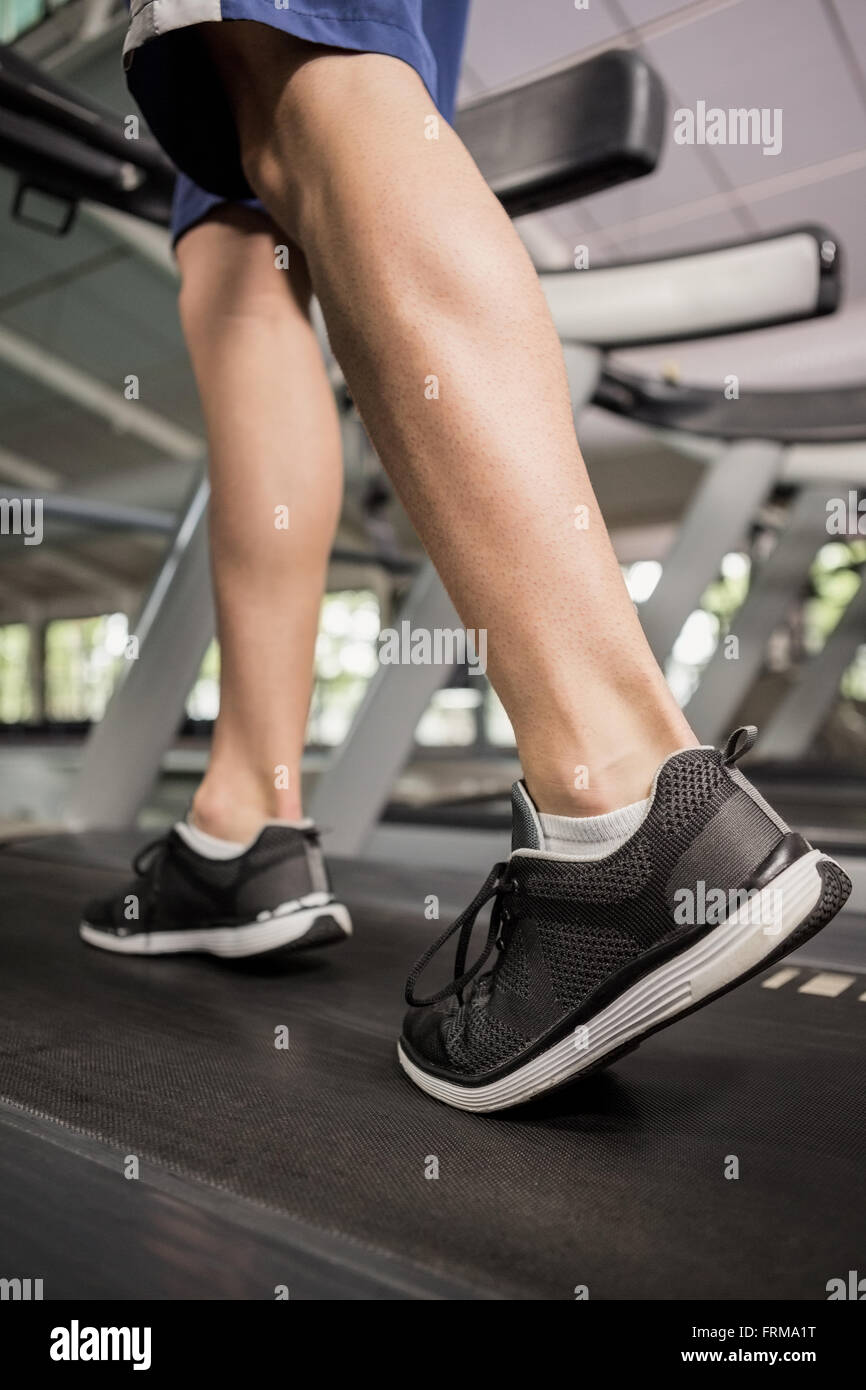 Man's feet while walking on thread mill Stock Photo - Alamy