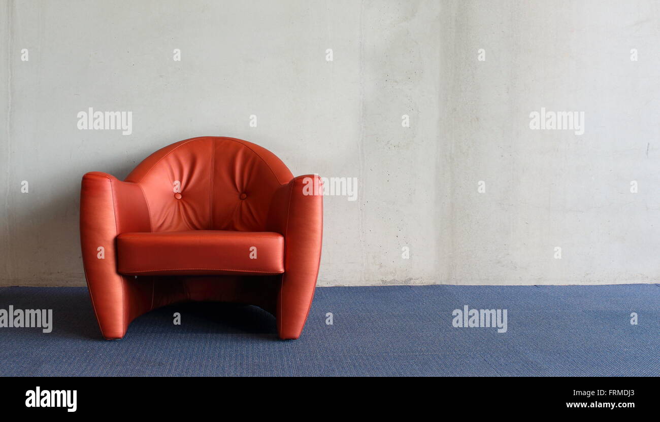 Red Chair – Stylish modern new red chair in front of brick wall Stock ...