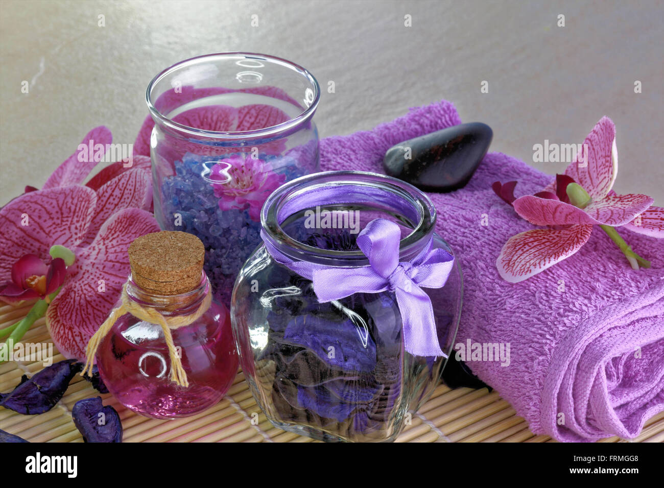 Spa treatment setting with purple theme Stock Photo - Alamy