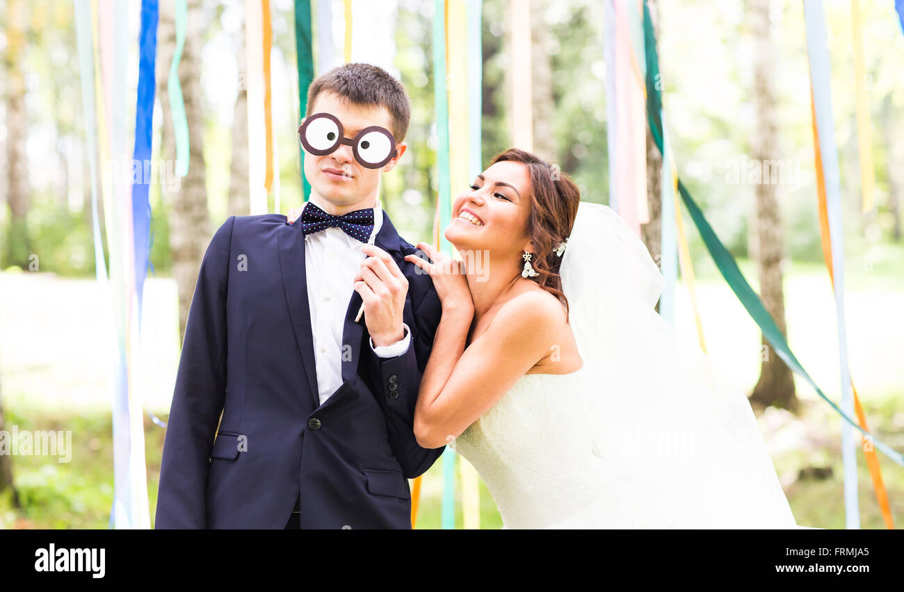 April Fools' Day. Wedding couple have fun with mask Stock Photo - Alamy