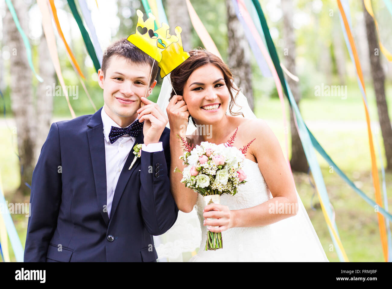 April Fools' Day. Wedding couple posing with crown, mask Stock Photo ...