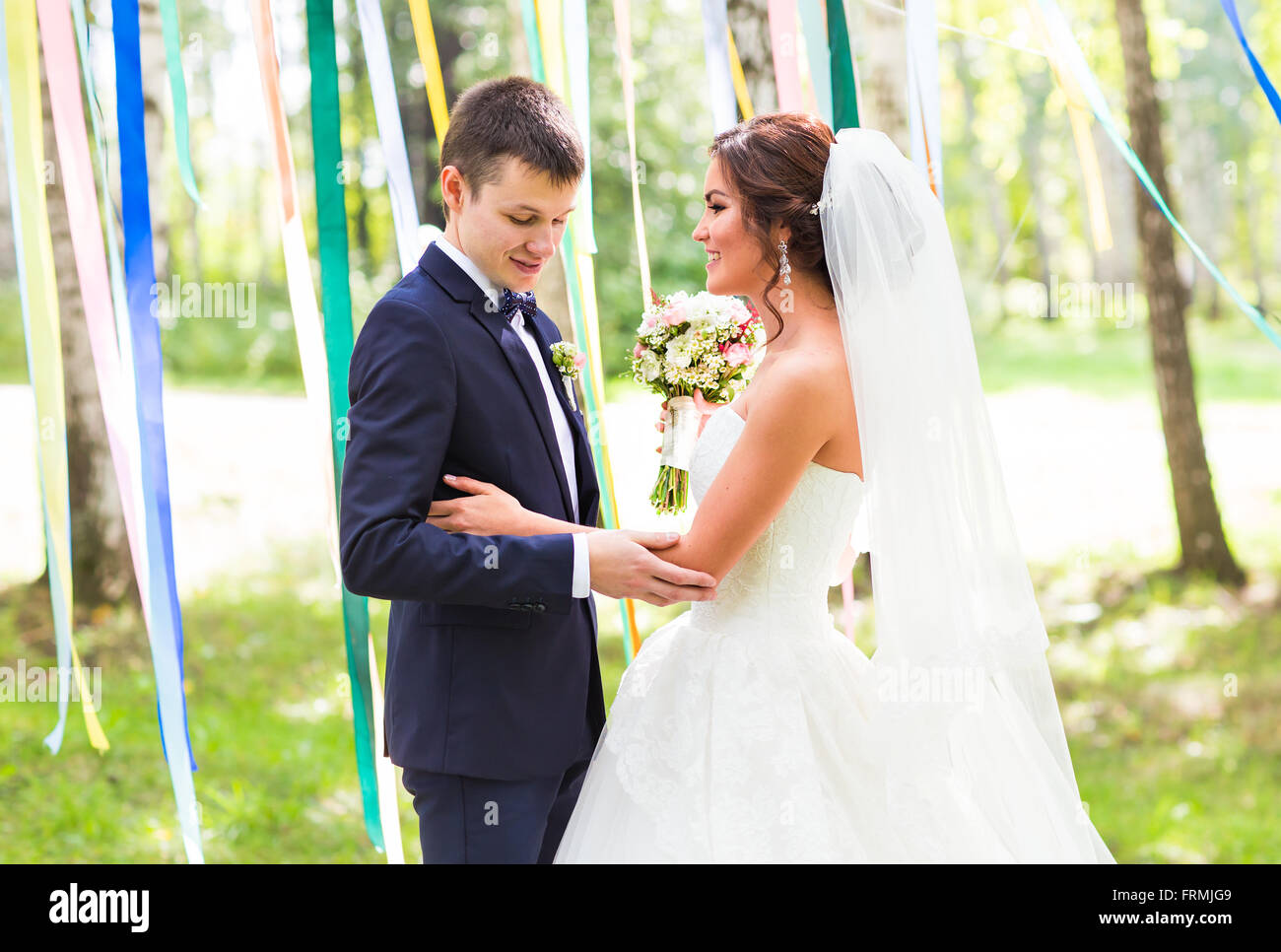 Bride and groom at wedding Day walking Outdoors on spring nature Stock ...