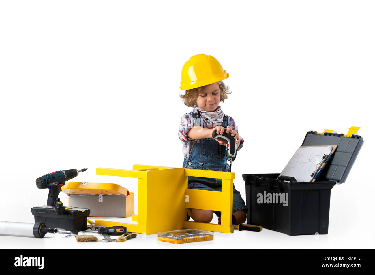 Little boy dressed as utility worker with protective helmet trying to ...