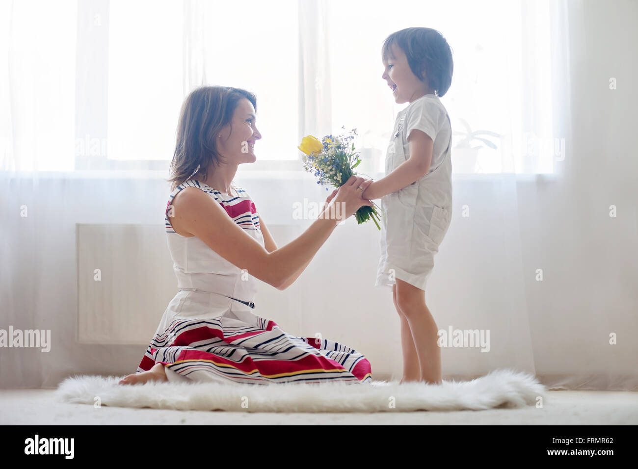 Mother and her child, embracing with tenderness and care, child giving ...