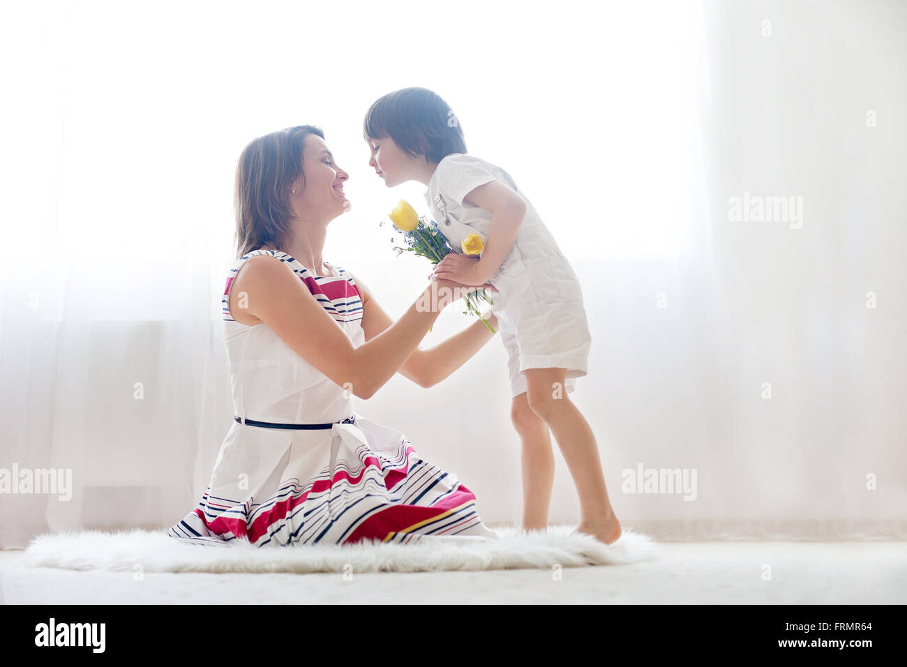 Mother and her child, embracing with tenderness and care, child giving ...