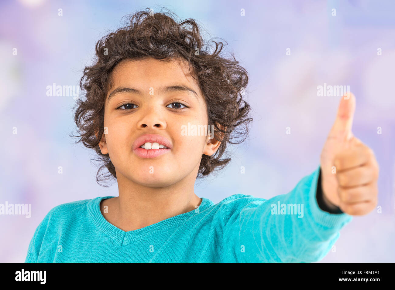 happy boy is showing his left thumb up Stock Photo - Alamy