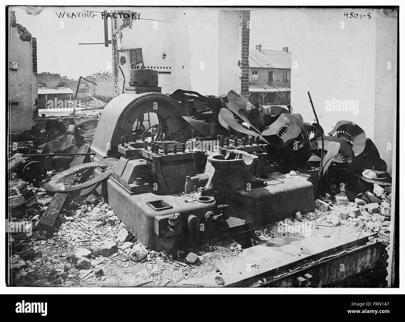 A historical photograph of a weaving factory, depicting the machinery ...