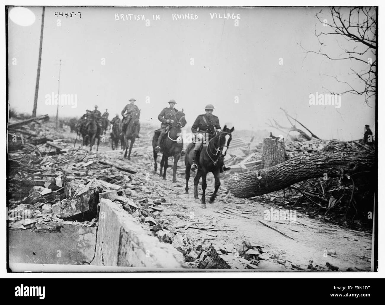 This photograph depicts British soldiers in a war-torn village, a stark ...