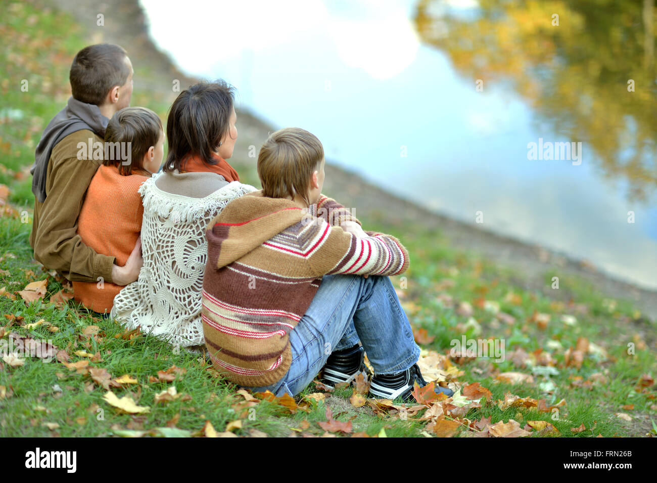 smiling family relaxing Stock Photo - Alamy